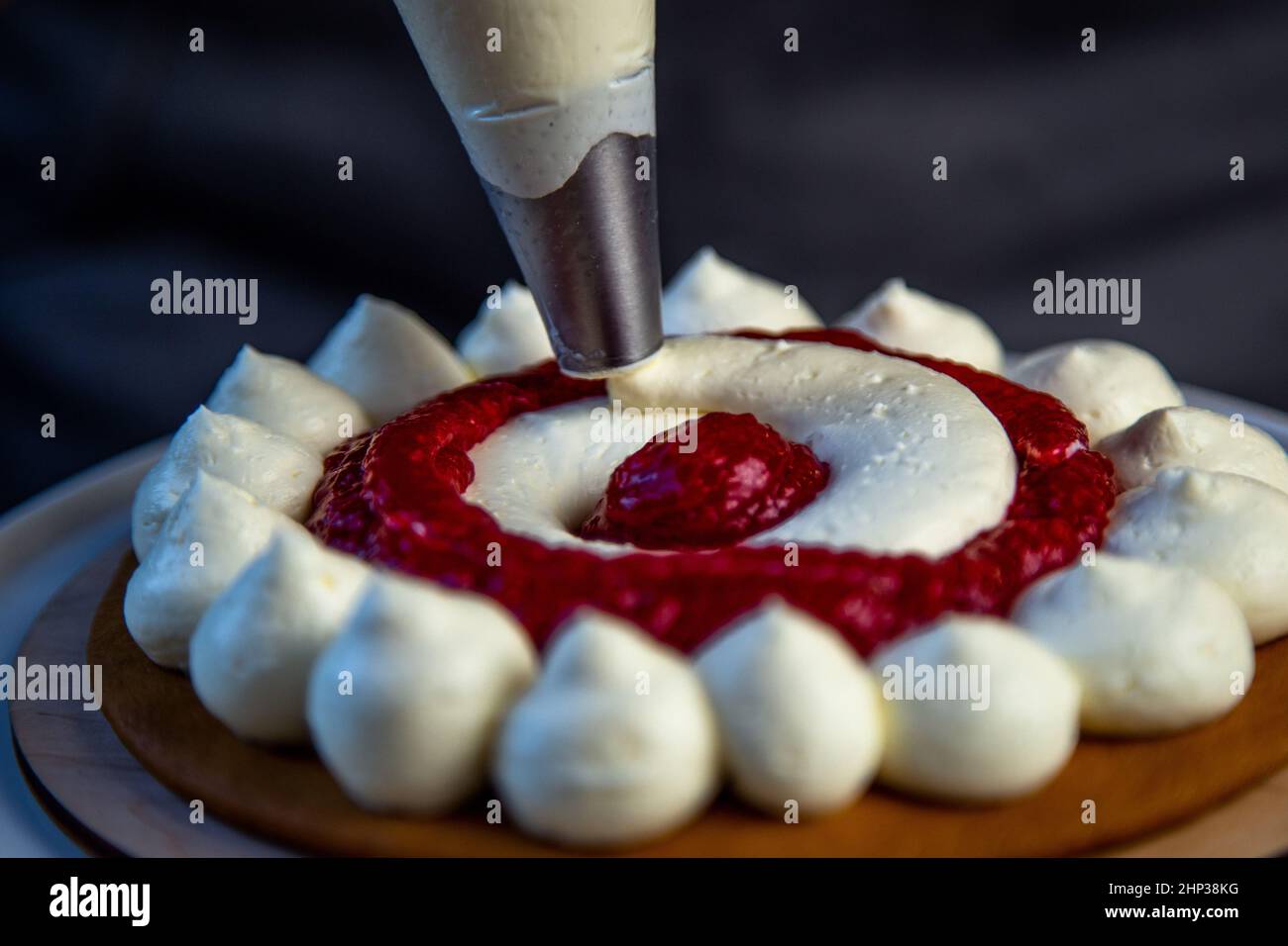 The baked cake cake lies on a wooden substrate and on a white stand ...