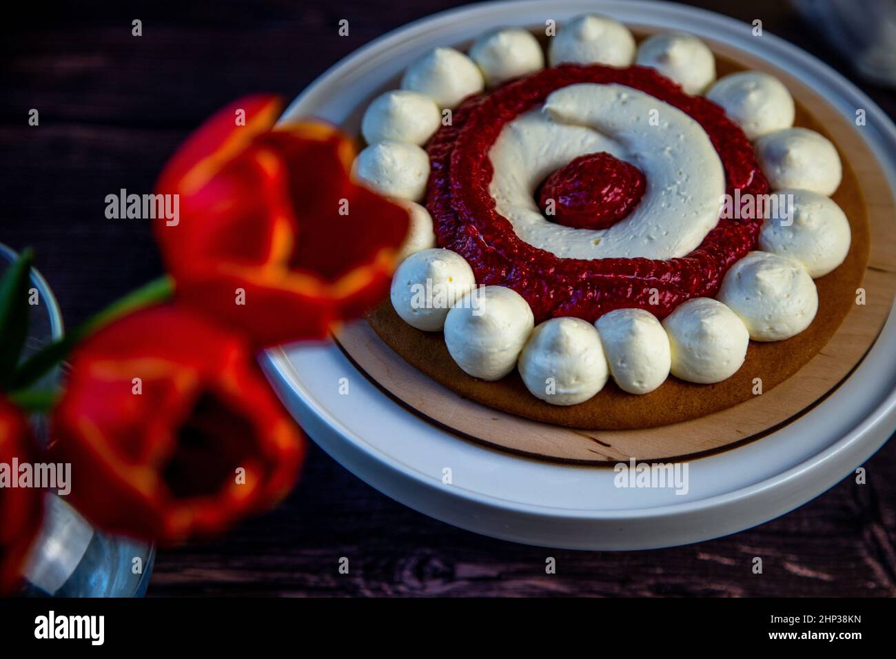 The baked cake cake lies on a wooden substrate and on a white stand ...