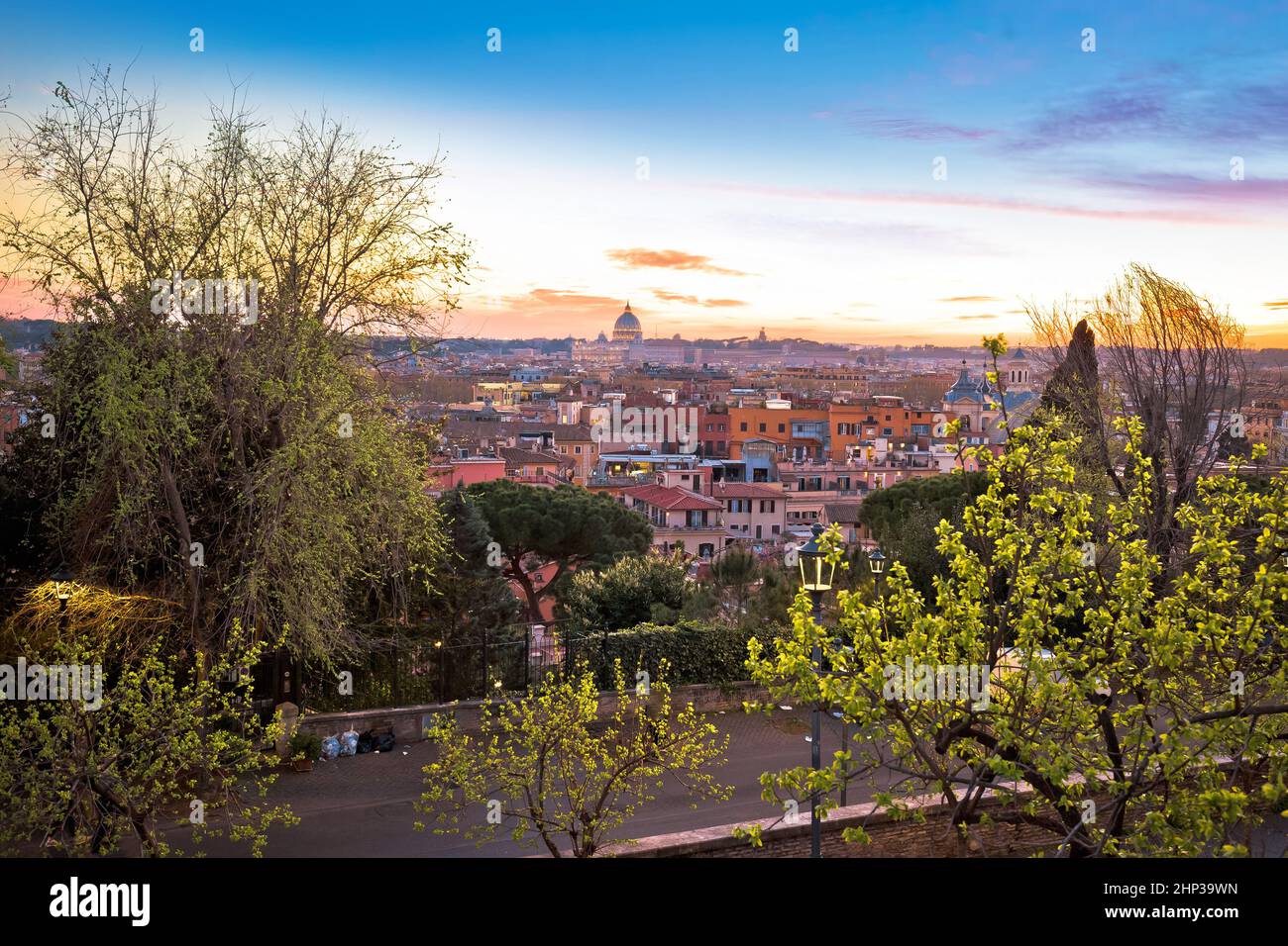 Rome. Colorful dusk view of Rome and Vatican rooftops and landmarks, eternal city and capital of ...
