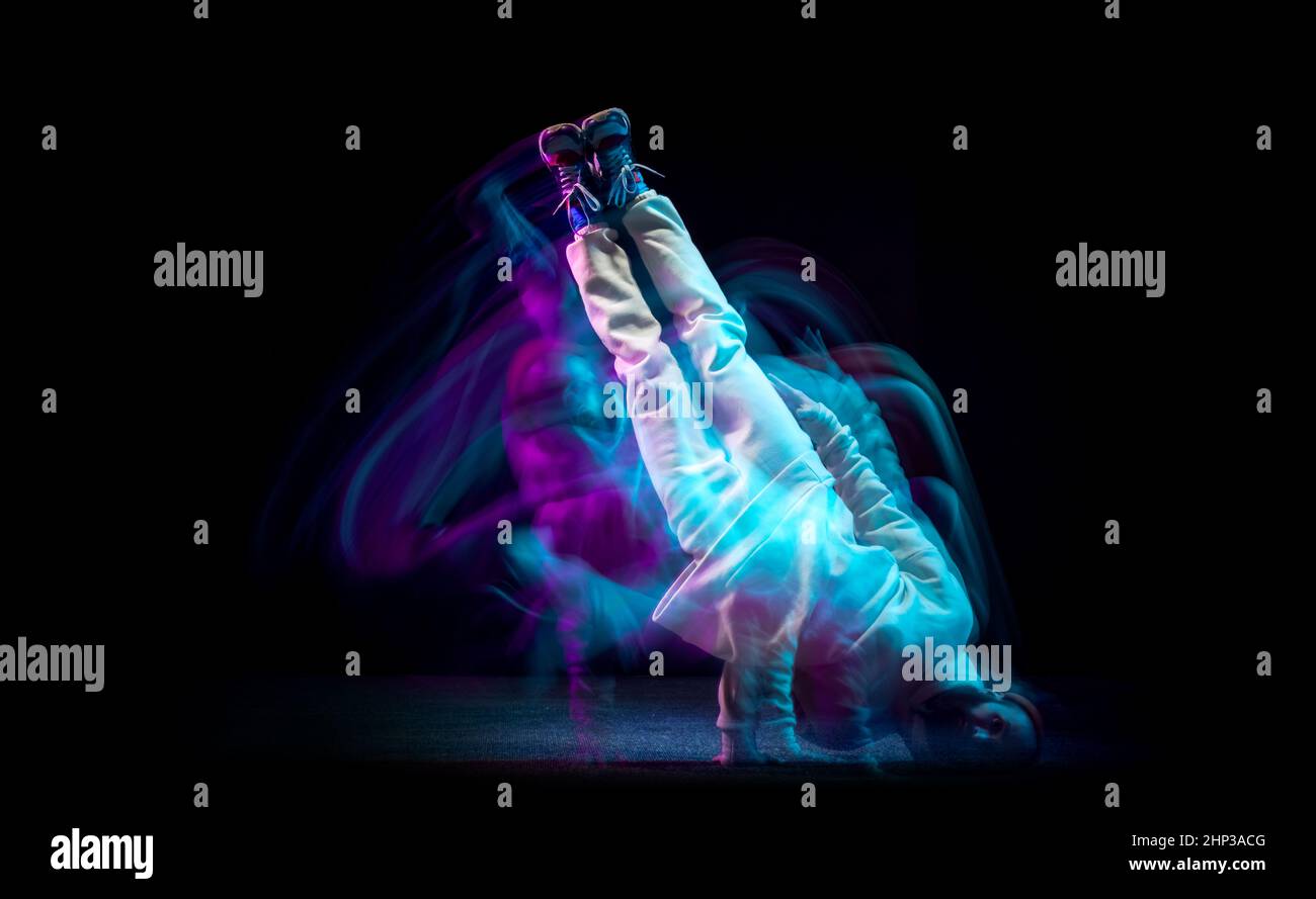 Hand stand. One energy young flexible sportive man dancing hip-hop or ...