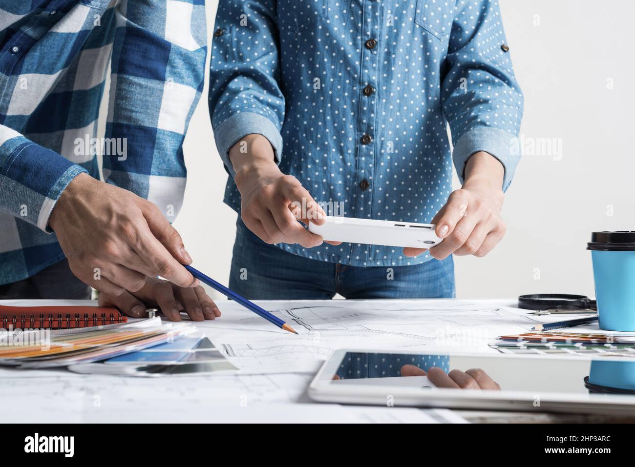 Woman taking photo of technical drawing Stock Photo - Alamy