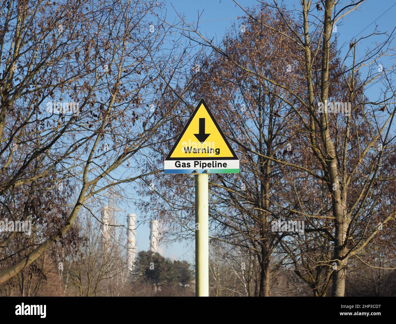 Warning gas pipeline sign and power station in the background Stock ...