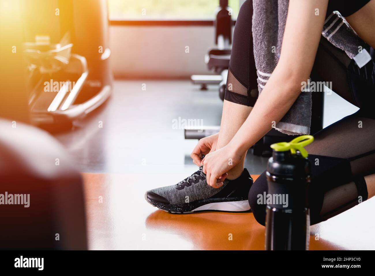 Young woman girl lifestyle sport tied shoelace before training workout exercise cardio at ...