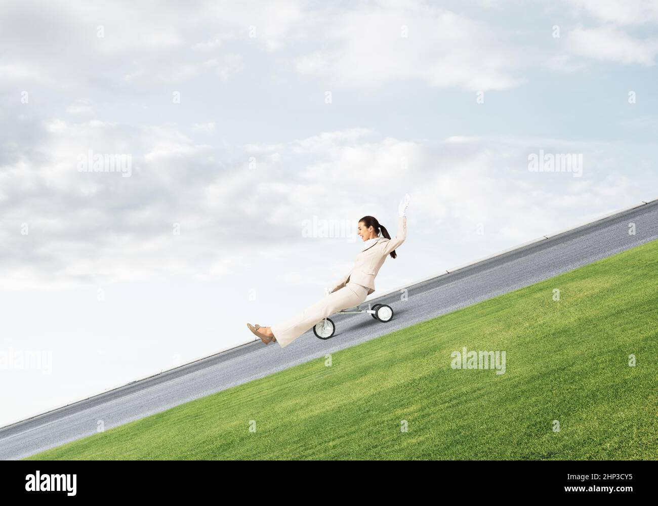 Beautiful happy woman riding downhill Stock Photo - Alamy