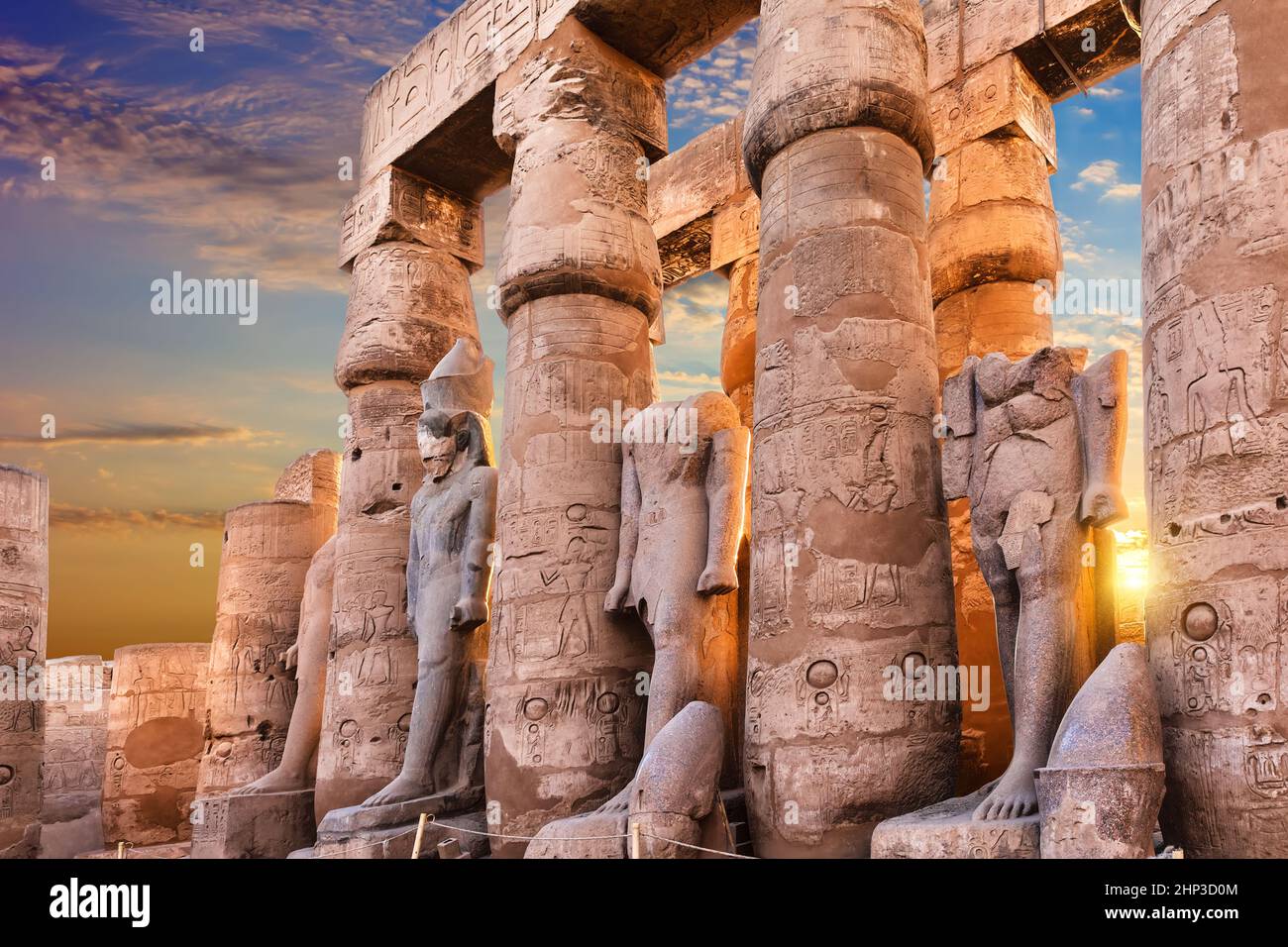Standing Ramses II statues in Luxor Temple, beautiful sunset view ...