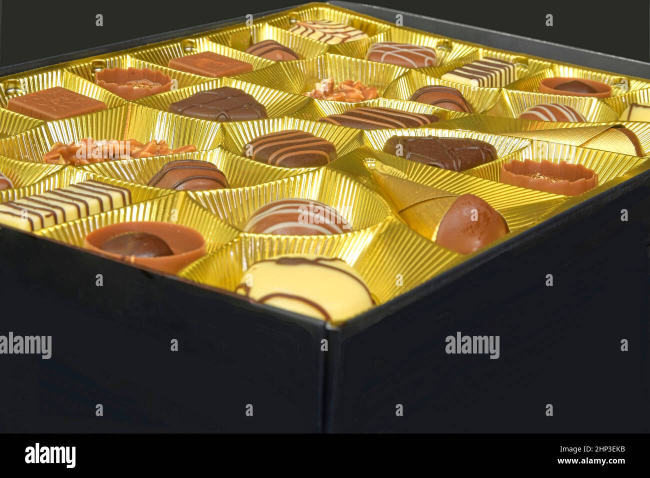 Different chocolate pralines. Box of belgian pralines of different ...