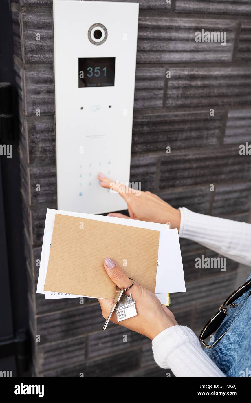 Door Access Control - A young woman, holding her mail in her hands ...