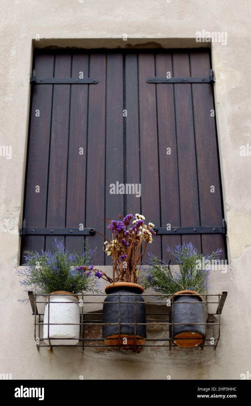 Wooden window covers with flowerpot decoration of Italian house Stock ...
