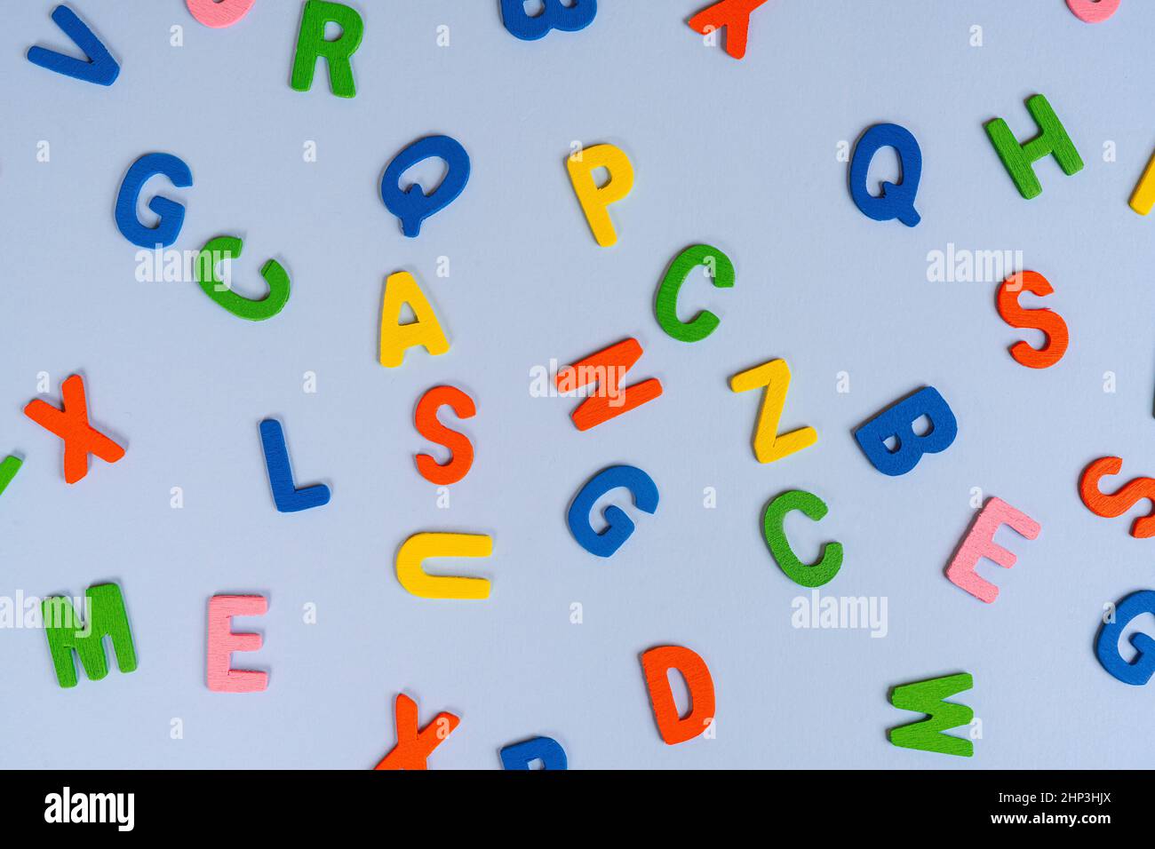 some letters of the alphabet colored on a blue surface Stock Photo - Alamy