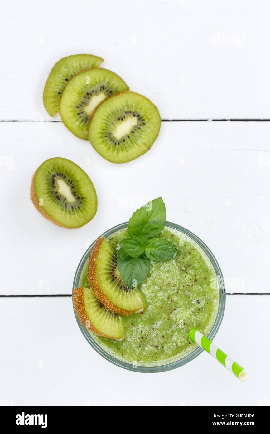 Green smoothie fruit juice kiwi drink in a glass from above portrait ...