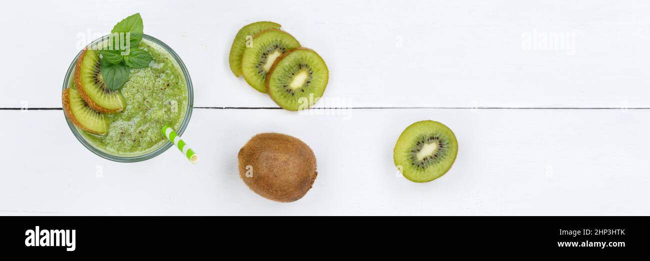 Green smoothie fruit juice kiwi drink in a glass from above panorama ...