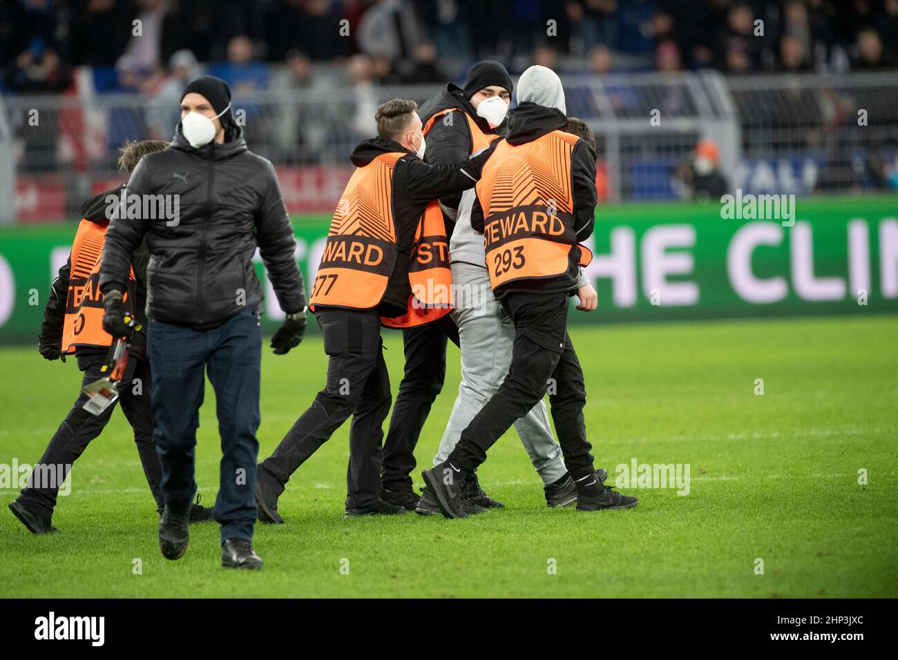 A streaker runs across the pitch and is caught by folders and carried ...