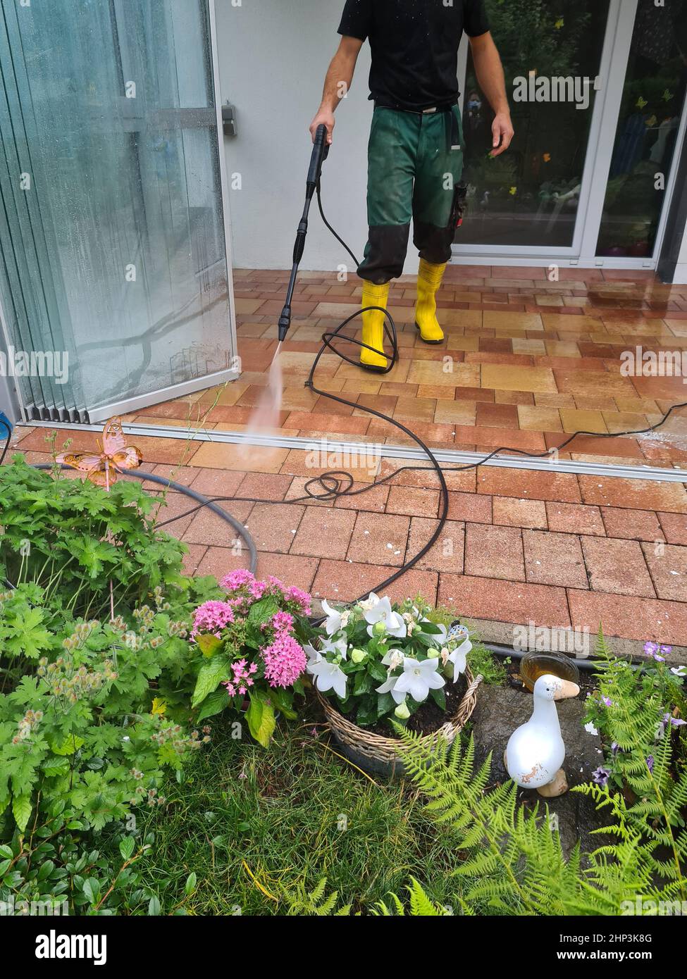 Man cleaning conservatory with a pressure washer - high pressure washer ...