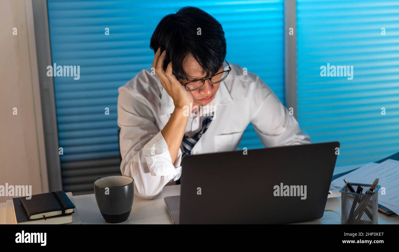 Overwork Concept The male officer resting his face on his right hand ...