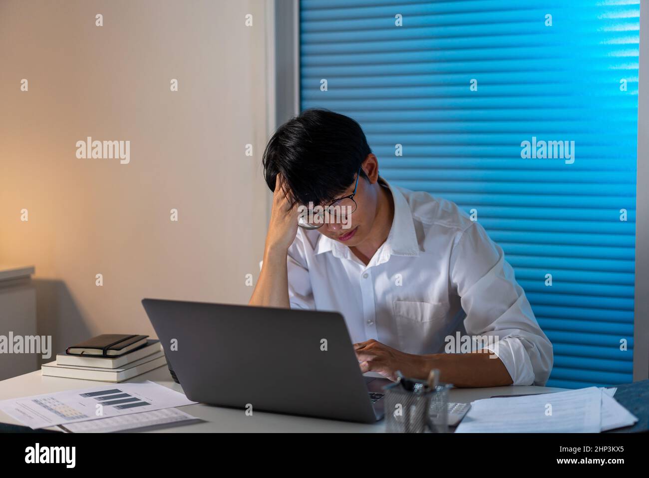 Overwork Concept The male officer resting his forehead on his right ...