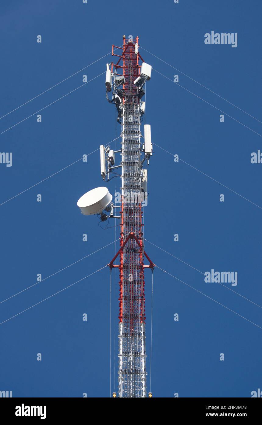Internet towers and transmission equipment on clean blue sky background ...