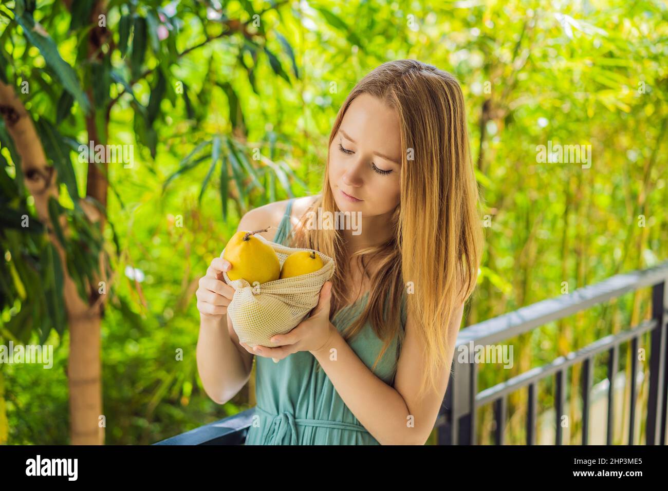 Mango in a reusable bag in female hands. Zero waste concept, plastic ...