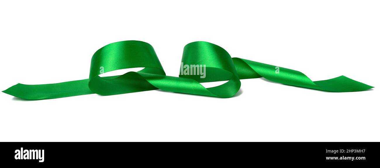 swirling green silk ribbon on white background, gift wrapping decor ...