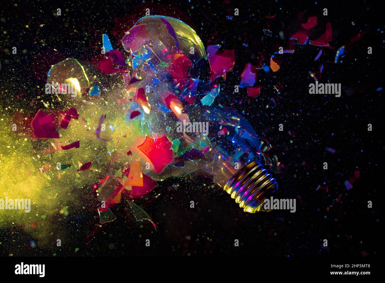 explosion of a colorful light bulb on black. high speed photography ...