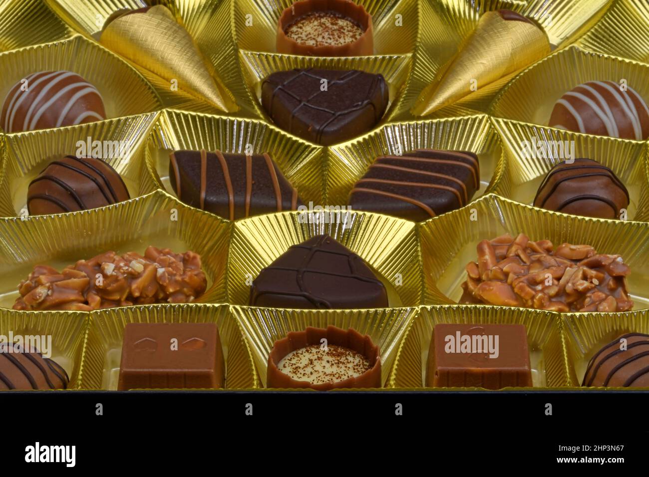 Different chocolate pralines. Box of belgian pralines of different ...