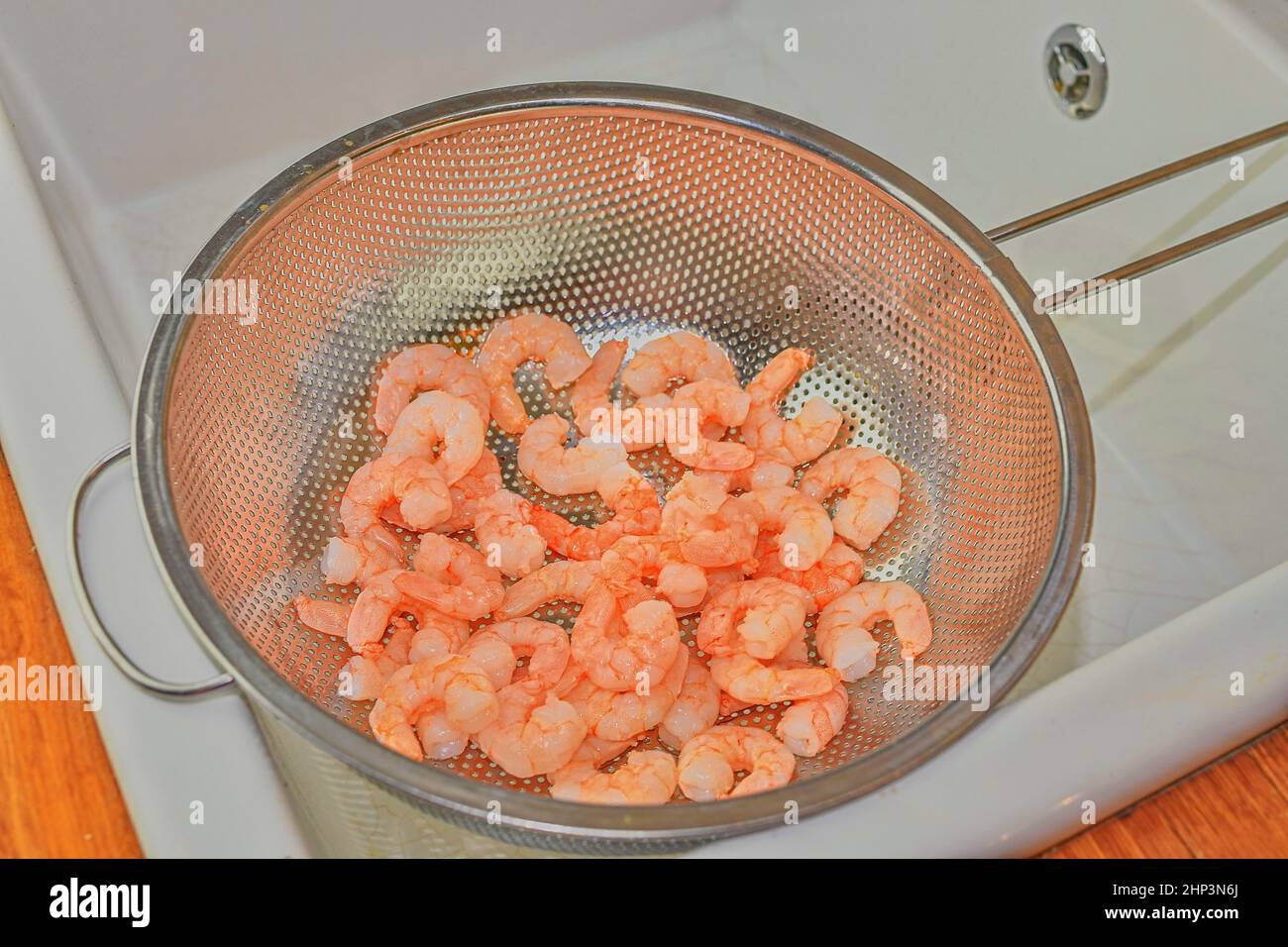Cooked and peeled prawns in strainer. Food photography. Healthy food ...
