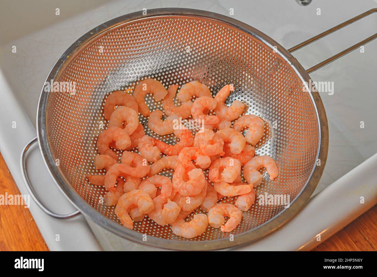 Cooked and peeled prawns in strainer. Food photography. Healthy food ...