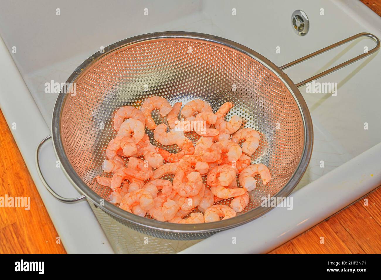 Cooked and peeled prawns in strainer. Food photography. Healthy food ...