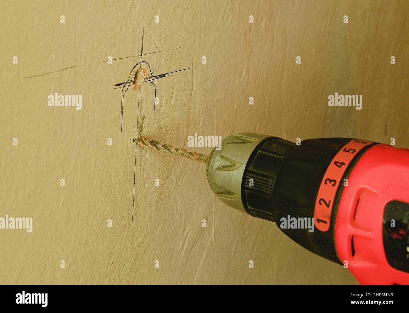 Closeup of drill machine. Drilling hole in the wall Stock Photo - Alamy