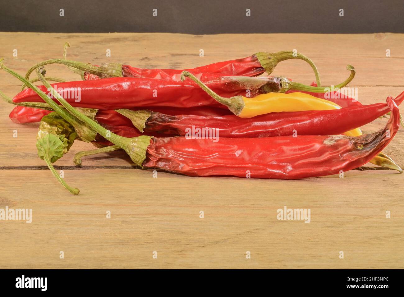 Shrinking and mould chili peppers on white wooden background. Rotten ...