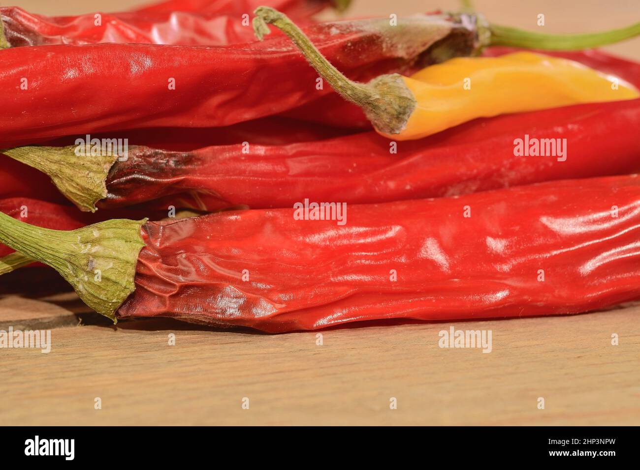 Shrinking and mould chili peppers on wooden background. Rotten chili ...
