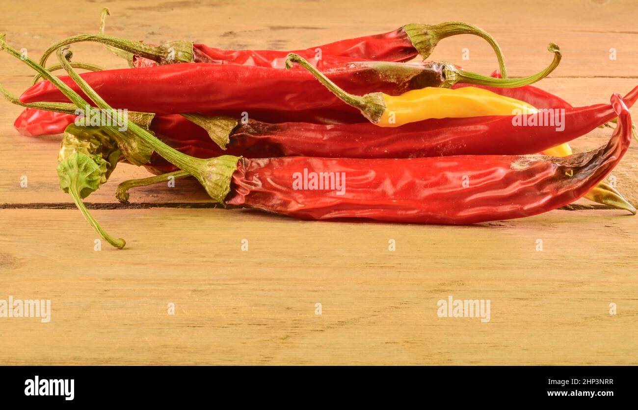 Shrinking and mould chili peppers on white wooden background. Rotten ...