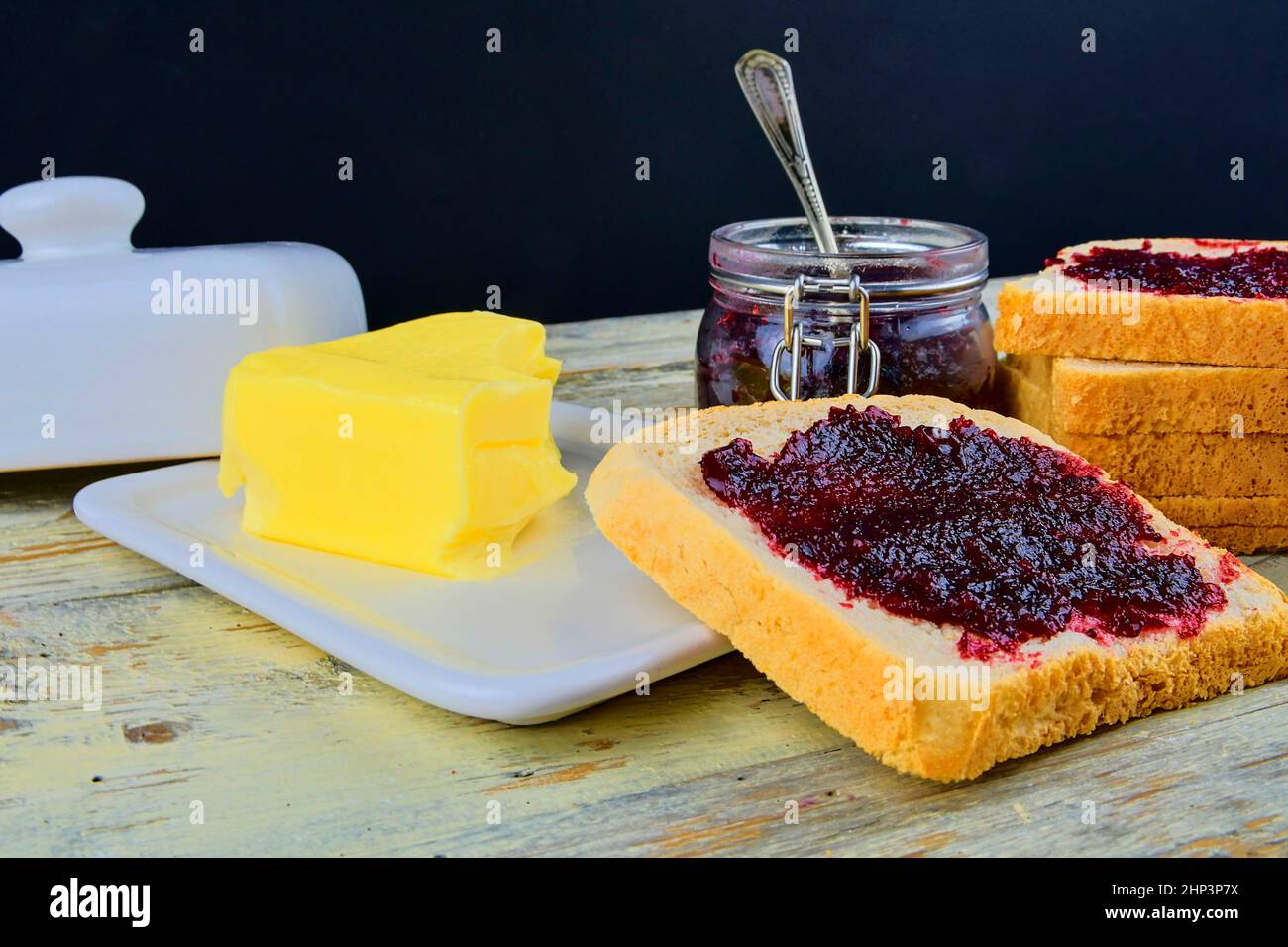 Jam, butter in butter dish and jam spread on toast. Healthy and diet ...