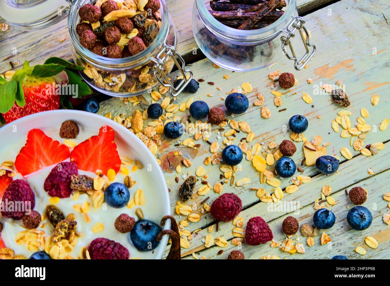 Healthy breakfast, cereal with yoghurt, strawberries, blueberries ...