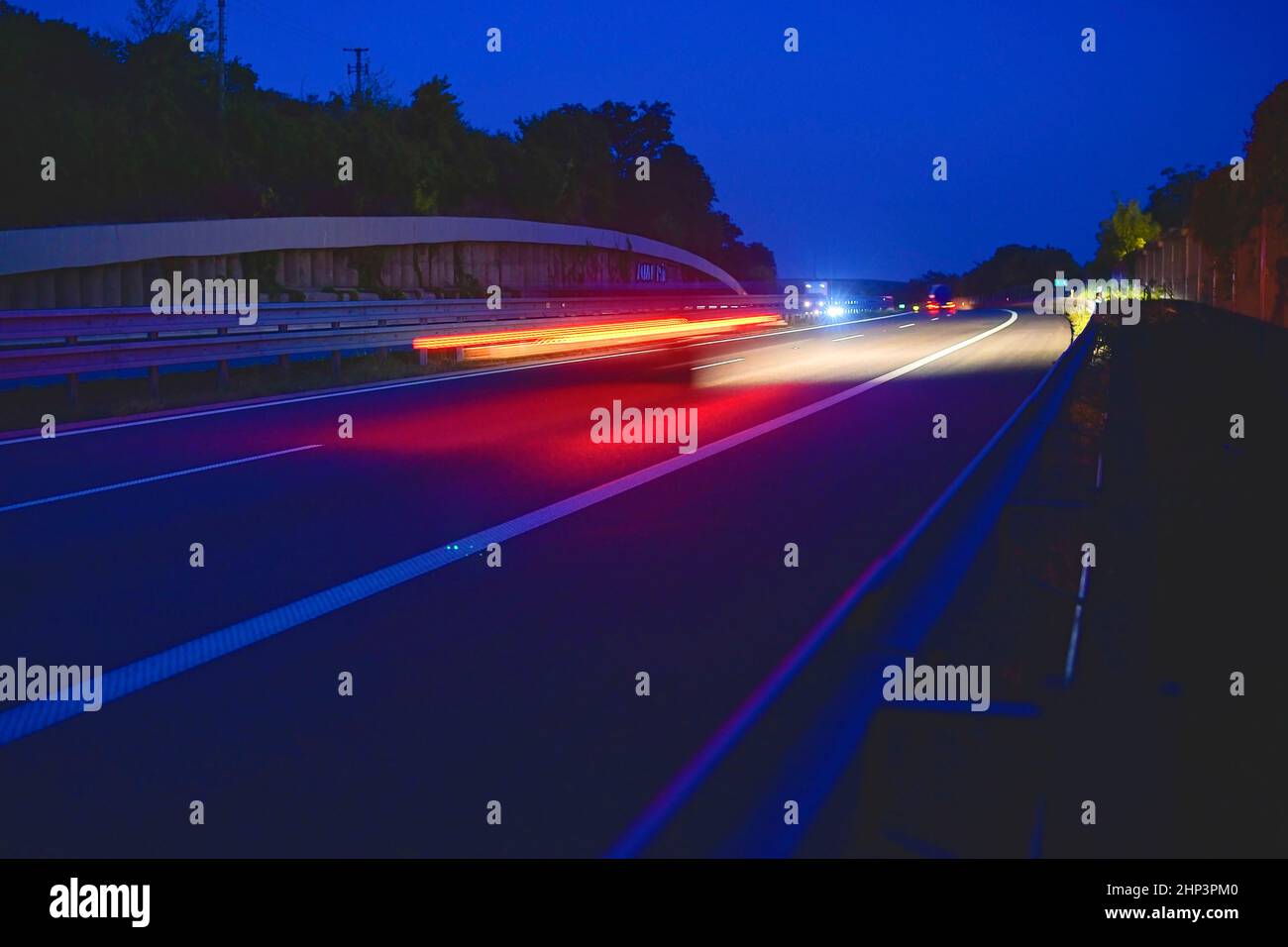 Evening shot of trucks doing transportation and logistics on a highway ...