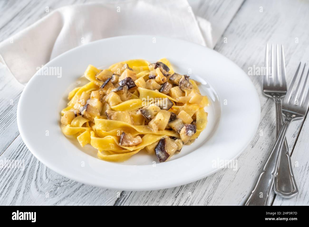 Creamy garlic eggplant and parmesan tagliatelli pasta Stock Photo - Alamy