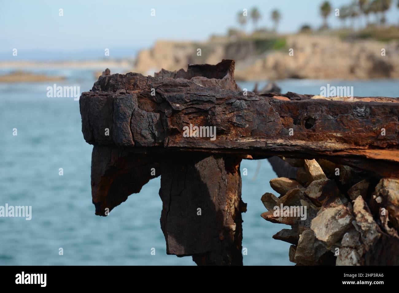 Remains of a rusted handrails on a waterfront on a background of sea ...