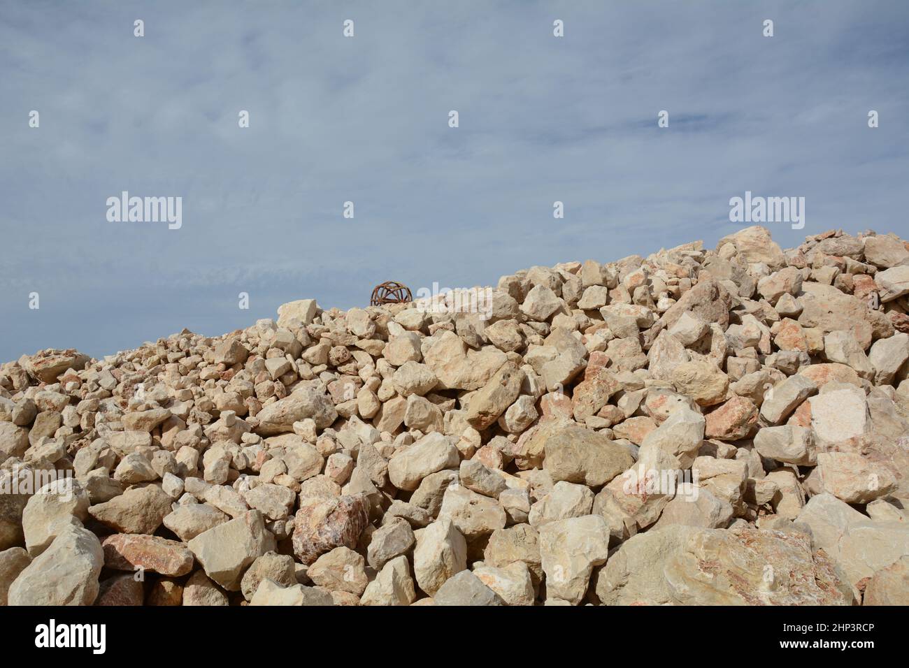 Photo of a large pile of stones at construction site, on the coastline ...
