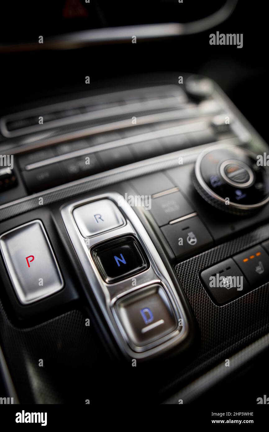 Close up shot of an automatic button gear shifter on a central console ...