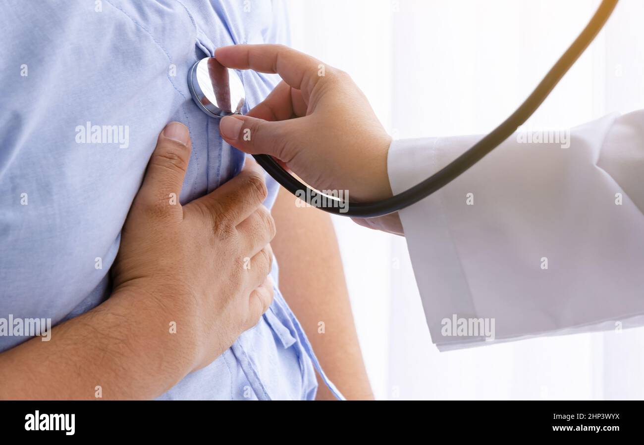 Doctor listening patients heartbeat in hi-res stock photography and ...