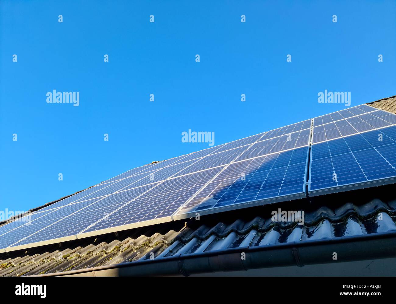 Solar panels producing clean energy on a roof of a residential house ...