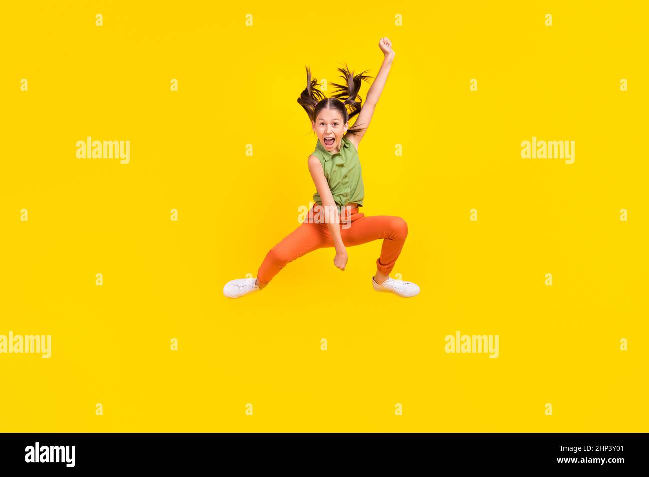 Photo of funky charming preteen girl dressed green top jumping high ...