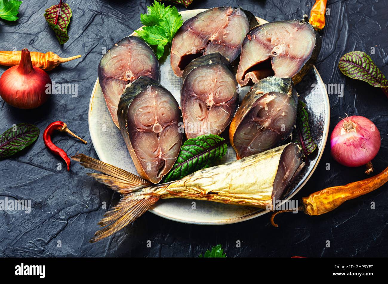 Plate with smoked scomber fish. Pieces of salted tuna mackerel ...