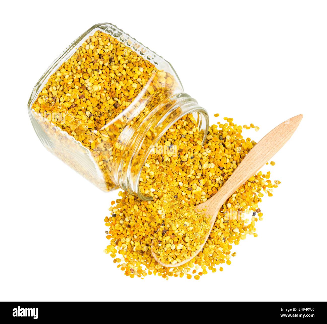 top view of wooden spoon in pile of bee pollen spilled from overturned ...