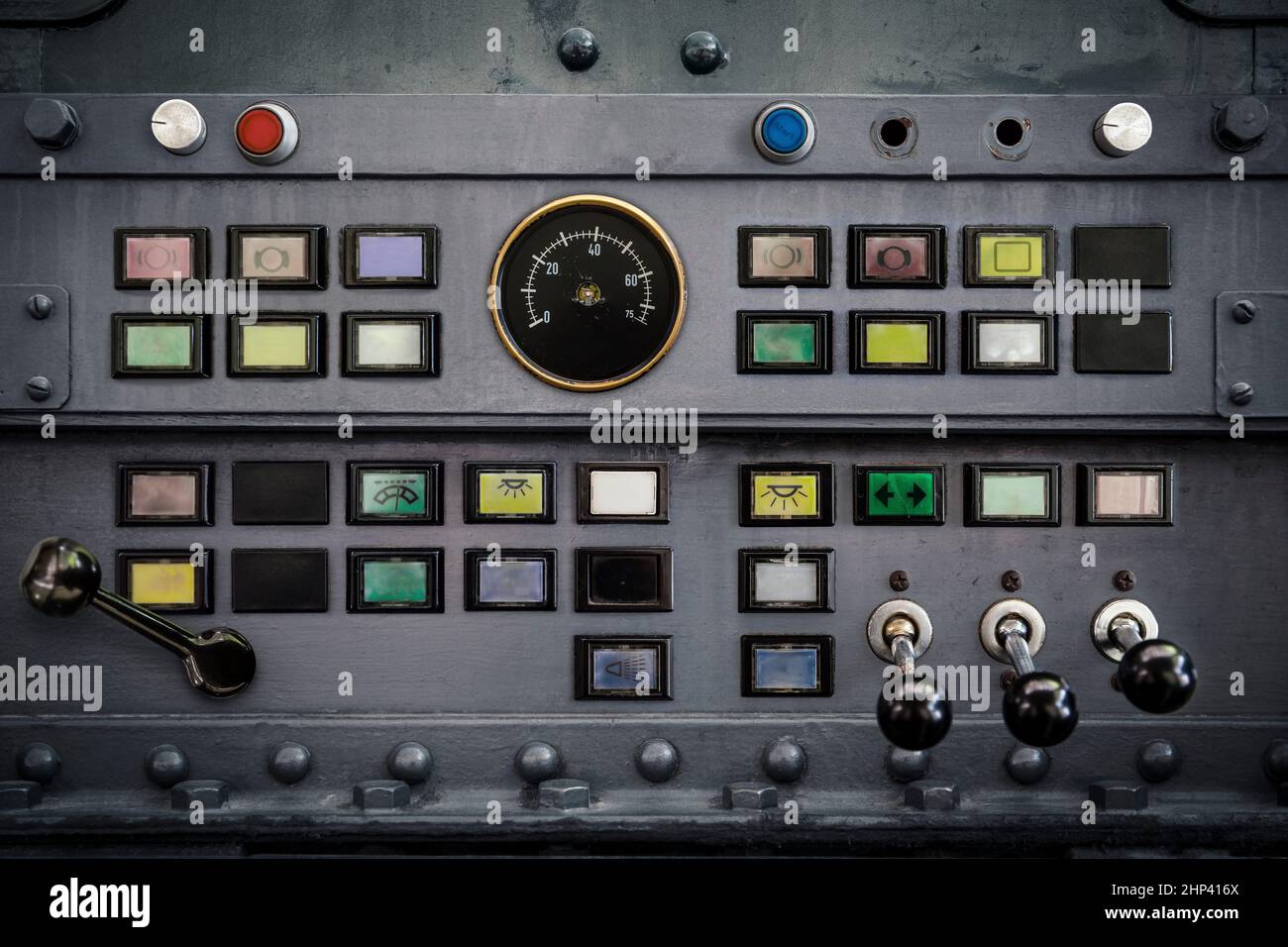 Old switches, buttons, and levers on a metal panel as a background for ...