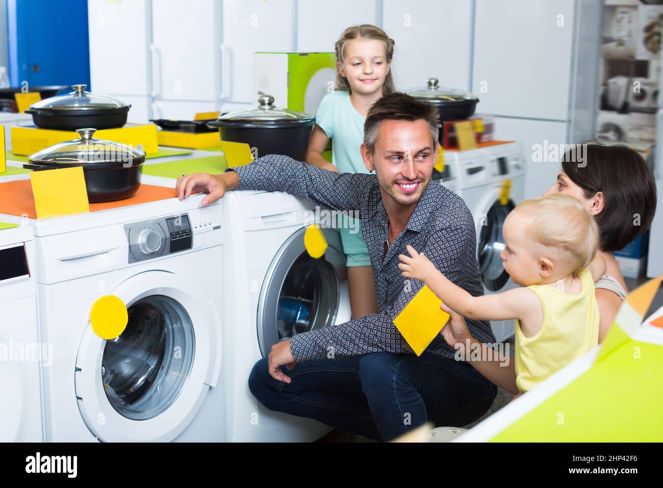 Adult family choosing washing machine Stock Photo - Alamy