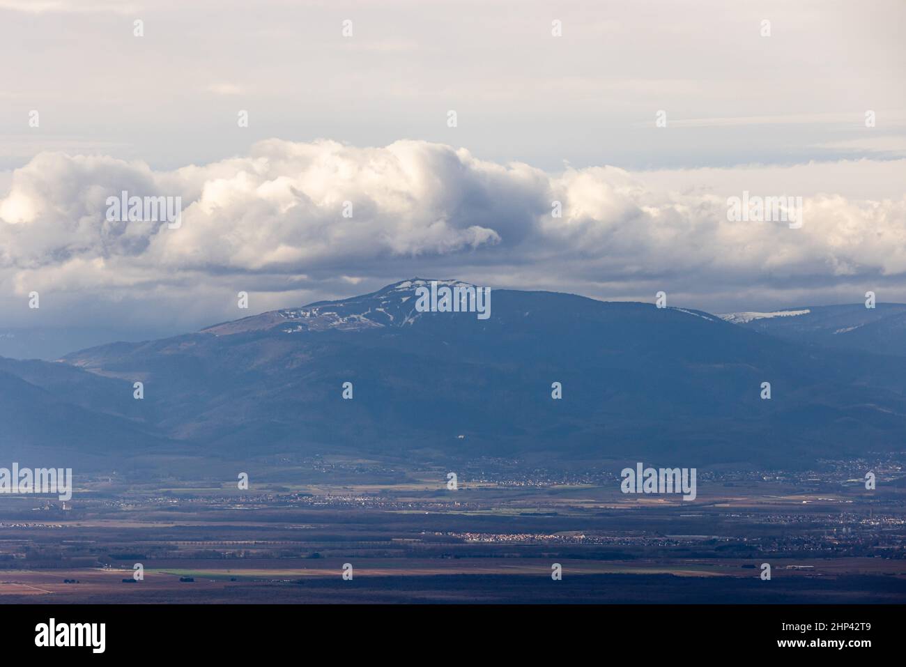 Schliengen, Germany. 18th Feb, 2022. Clouds stand over a partially snow ...
