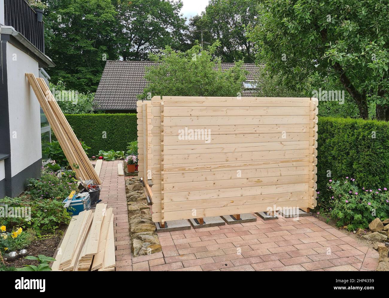 Garden shed built from tree trunks Stock Photo - Alamy