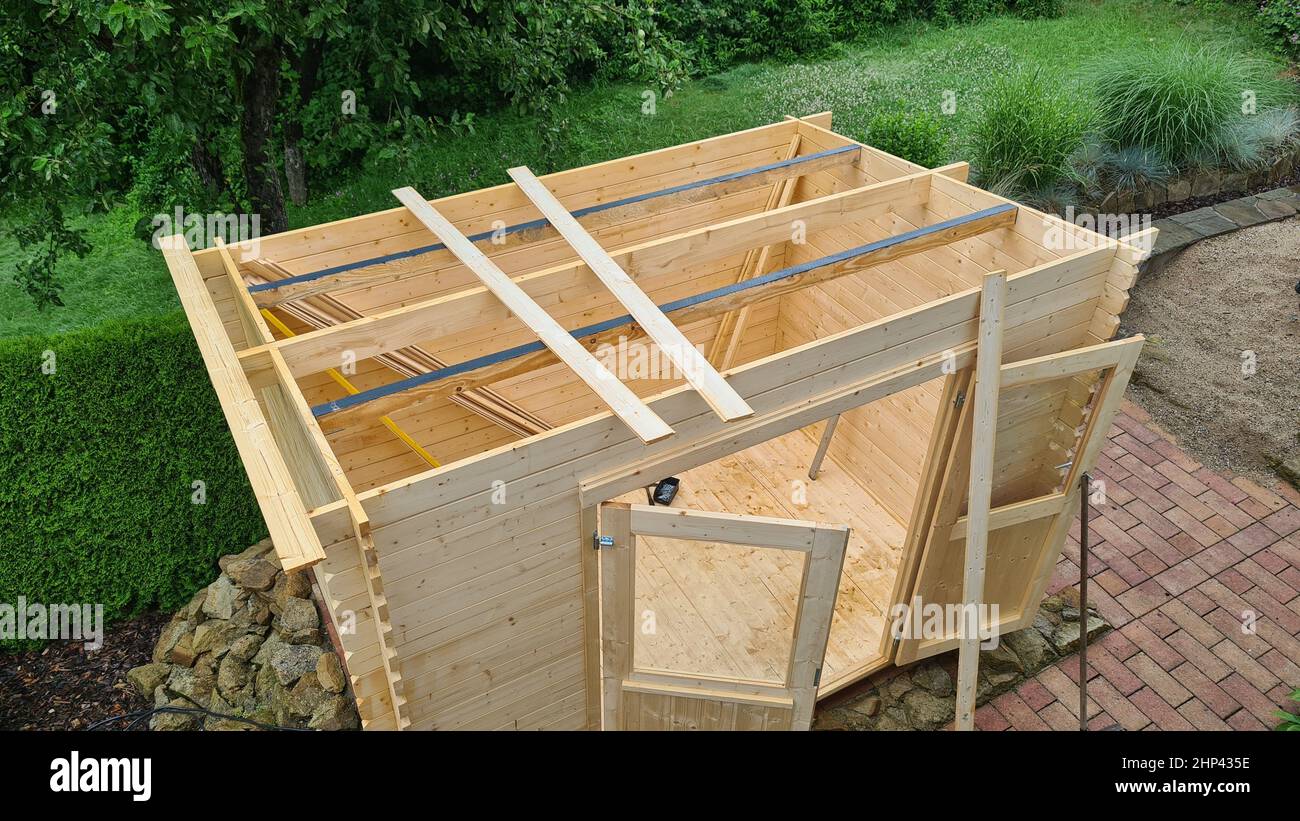 Garden shed built from tree trunks Stock Photo - Alamy
