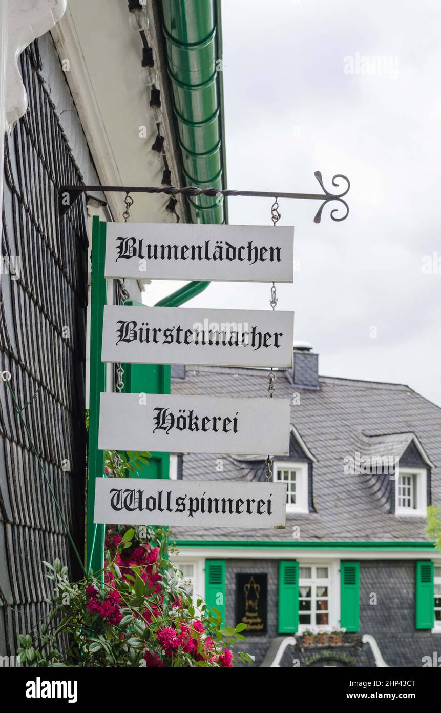 Slate house facade in a historic old town. Advertising signs at the ...