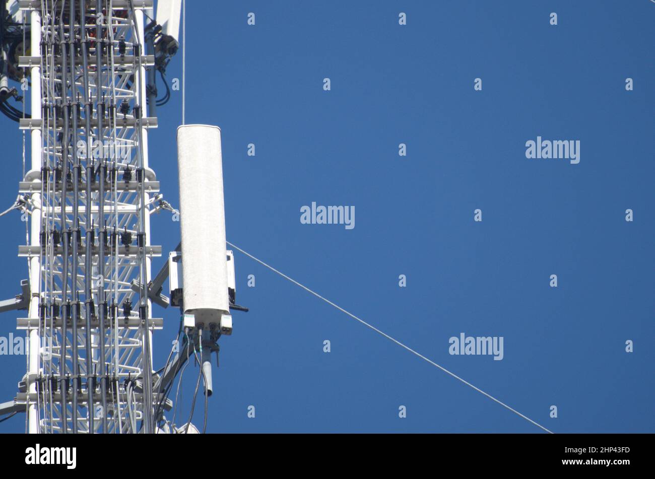 Internet towers and transmission equipment on clean blue sky background ...